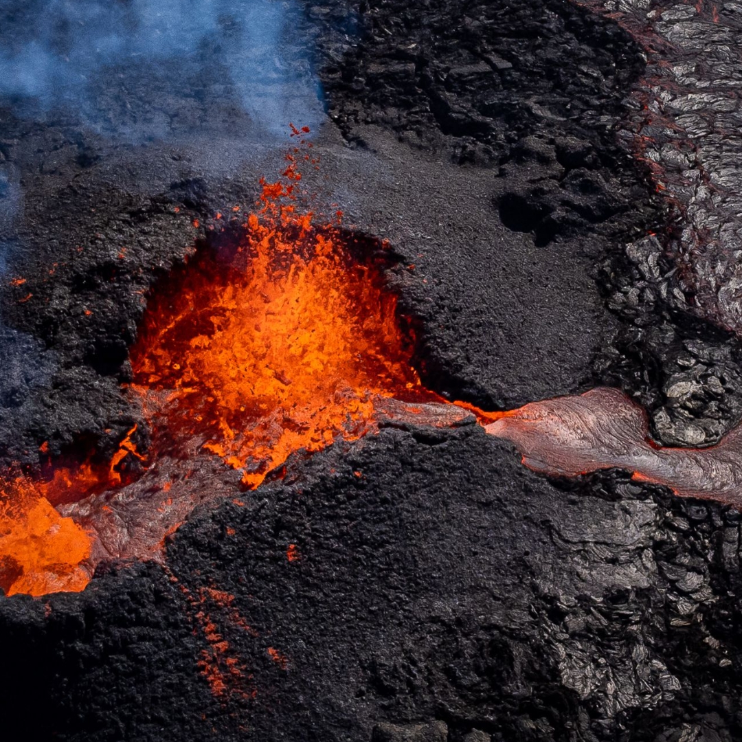 Magma flows from a heart-shaped volcano crater in Iceland