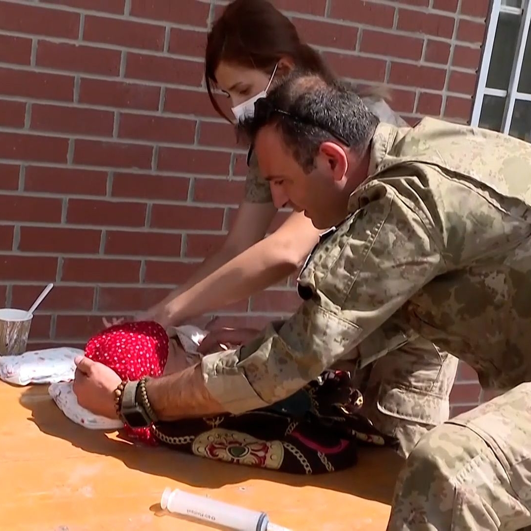 Turkish soldiers help care for baby separated from her mother at Kabul ...