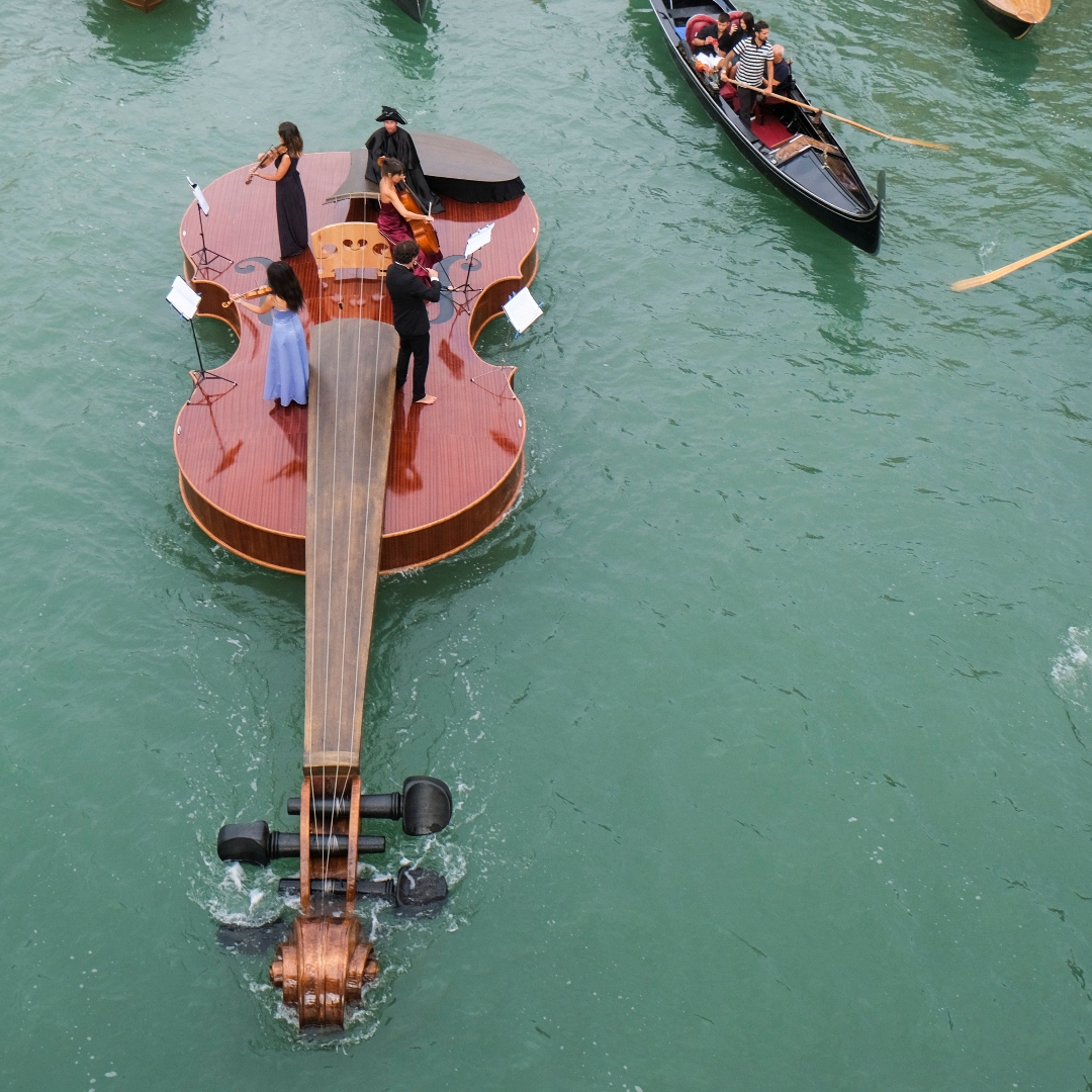 Watch a string quartet perform on a giant floating violin in Venice