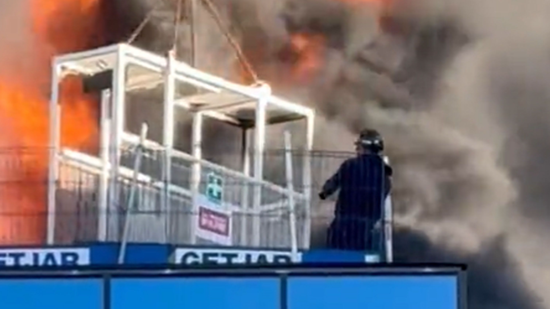 Trapped worker lifted to safety from burning high-rise building