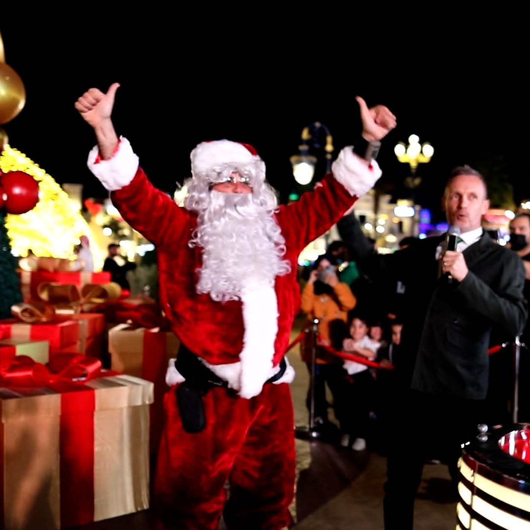 Santa parachutes into Global Village to light up giant tree